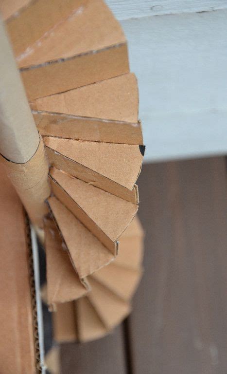 An Umbrella Made Out Of Brown Paper Sitting On Top Of A Wooden Floor
