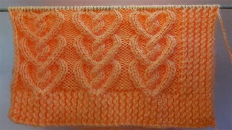 An Orange Knitted Piece Hanging On A Clothes Line With Yarn In The