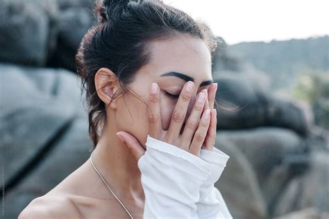 Brunette With Hands Hiding Her Face By Stocksy Contributor Viktor Solomin Stocksy