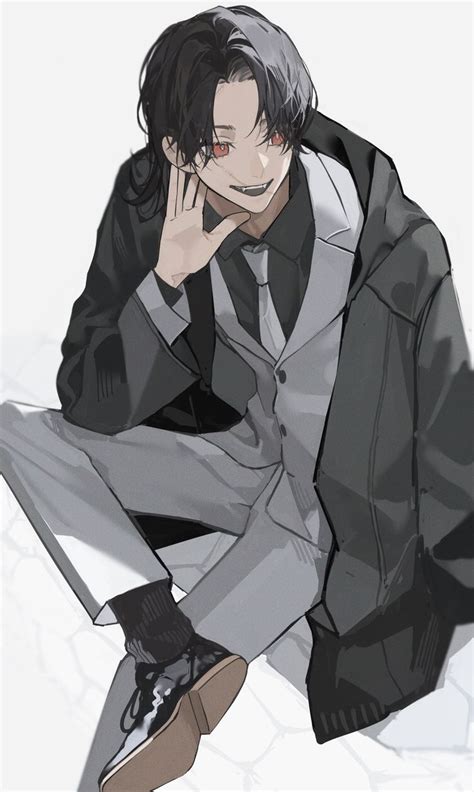 A Man Sitting On The Ground With His Hand To His Face Wearing A Suit