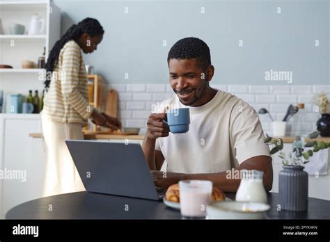 Homme afro américain utilisant un ordinateur portable tout en prenant