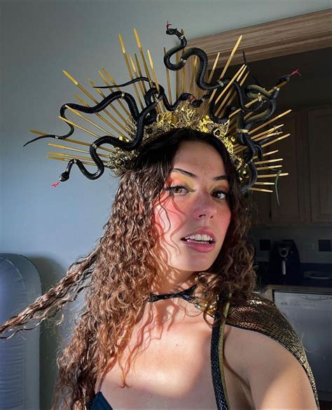 A Woman Wearing A Crown With Snakes On It S Head And Long Curly Hair