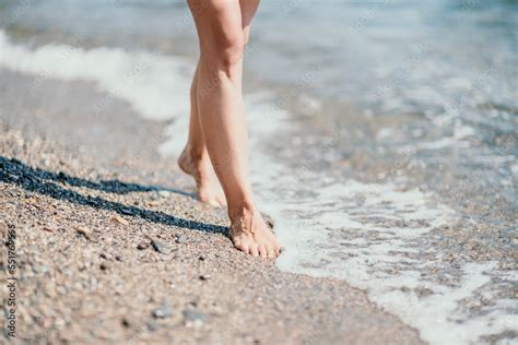 A Woman Walks Along The Beach Legs Close Up Barefoot Woman Standing