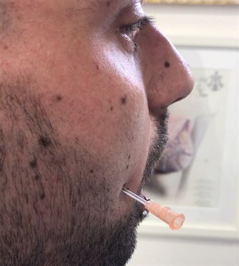 Piercing Cheek Officina Tattoo Milano