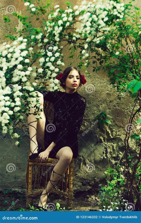 Woman In Black Lace Dress Sitting On Wicker Chair Stock Photo Image
