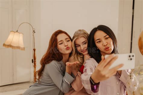 Beautiful Young Interracial Girls Take Selfie Blowing Kiss Into Smartphone Screen Stock Image