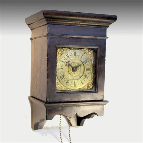 A Rare Th Century Early English Hooded Wall Clock In An Oak Case
