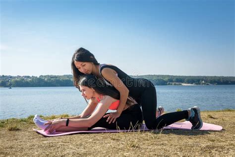 Young Slim Women Doing Stretching Exercise Relaxing And Warm Up After Jogging And Running In