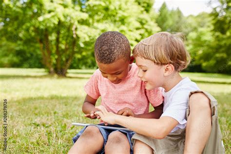 Zwei Kinder haben Spaß am Tablet PC Stock Photo Adobe Stock