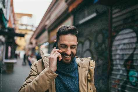 Handsome Bearded Man With Brown Coat In An Urban Scenery Del
