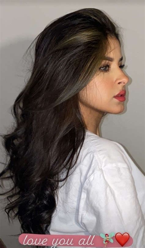 A Woman With Long Black Hair And White Shirt