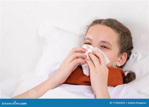 Girl In Bed Blows A Snot From Her Nose Into A Napkin Stock Image