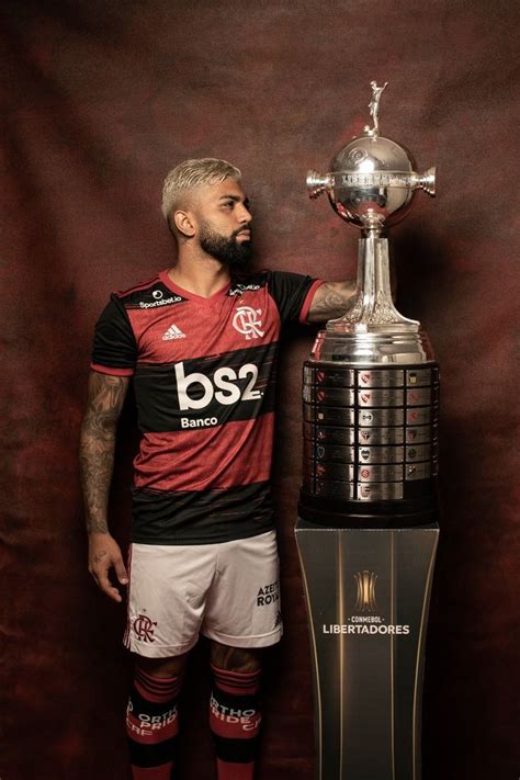 A Man Standing Next To A Soccer Trophy