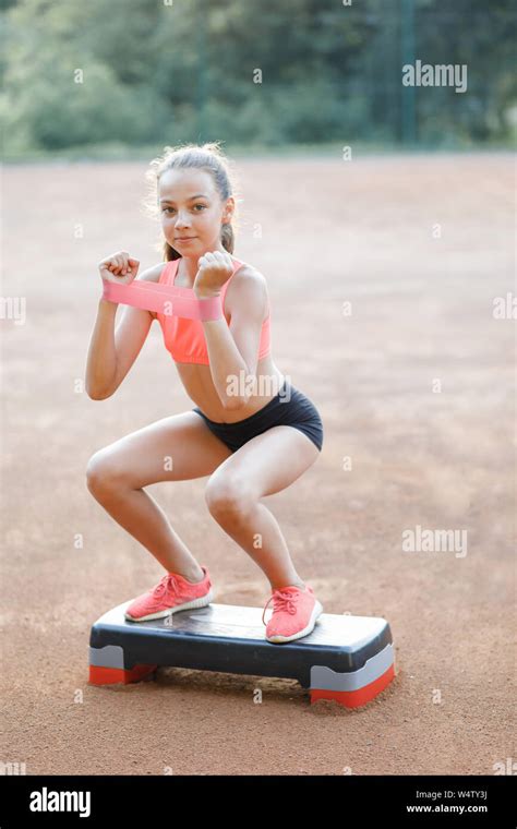 A Young Pretty Girl Of Slender Body Dressed In A Sports Uniform Spends Time On A Sports