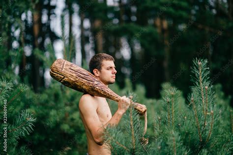 Odd Primitive Naked Man With Huge Wooden Stick Hunting In Forest Adult