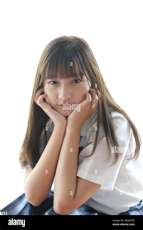 Portrait Japanese School Girl Uniform Sitting And Look At Camera In White Tone Bed Room Stock