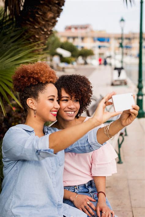 Afro Women Using A Mobile Phone For A Selfie By Stocksy Contributor