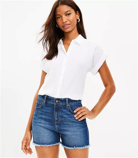 High Rise Frayed Cut Off Denim Shorts In Staple Mid Indigo Wash