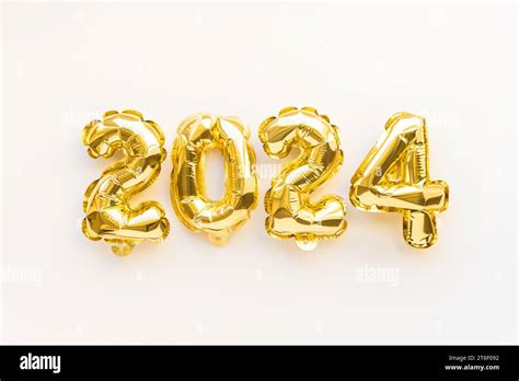 Golden Foil Balloons In Form Of Numbers 2024 On White New Year Card