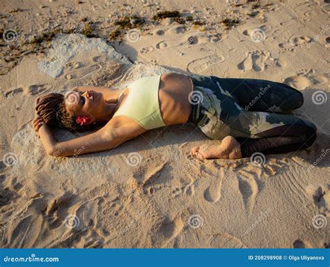 Yoga On The Beach Beautiful Woman Lying On The Sand Practicing Supta