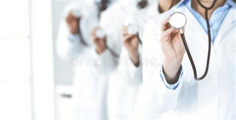 Group Of Doctors Holding Stethoscope Head Close Up Physicians Ready To