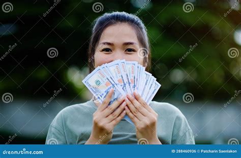 Dollar In The Hands Of An Asian Woman Savings Investments Salary Income Cash Flow Happiness