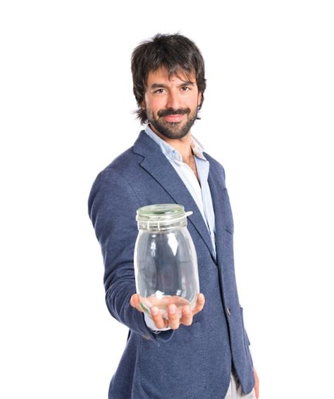 Free Photo Handsome Man Holding An Empty Glass Jar Over Isolated