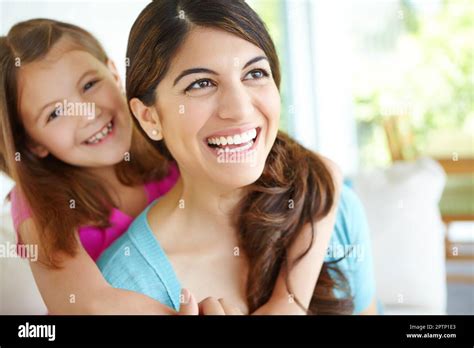Good Times With Mother And Daughter A Lovely Young Mother Smiling As Her Daughter Gives Her A