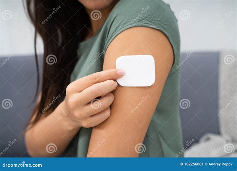Woman Applying Patch On Her Arm Stock Image Image Of Substitute