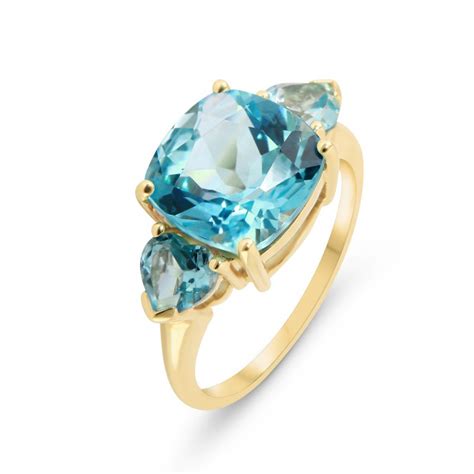 Bague Or Jaune 375 Topaze bleue traitée Traitée Coussin et Coeur Ref 51416