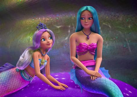 Two Cartoon Mermaids Sitting Next To Each Other