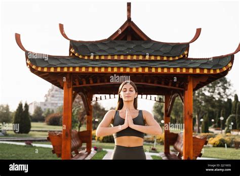 Qigong Chinese Meditation And Sport Training Outdoor Fit Asian Girl Is Meditating Outdoor Near
