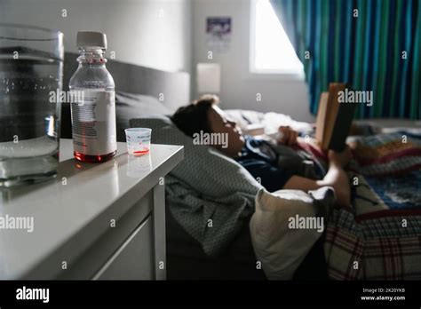 Jarabe para la tos en la mesilla de noche por un niño enfermo