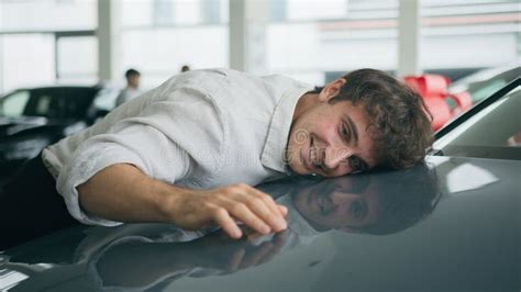 Happy Caucasian Man Driver Buyer Excited Guy Client In Auto Automobile Salon Choose New Auto