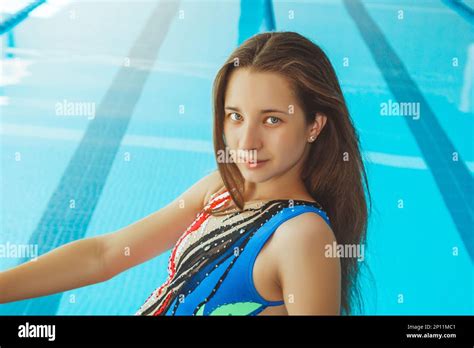 Portrait Of A Beautiful Young Girl Swimmer In A Beautiful Swimsuit On The Background Of The Pool