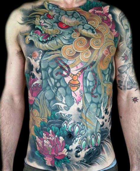 A Man With Tattoos On His Body And Chest