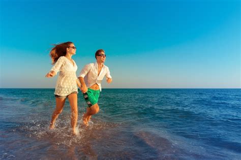 Feliz Pareja Joven Disfrutando Del Mar Foto Premium