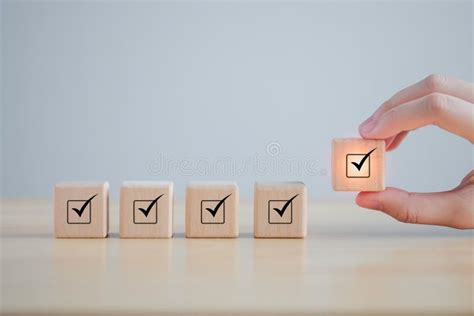 Hand Holding Check Mark On Wooden Blocks For Complete Check List