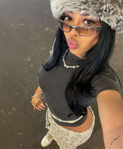 A Woman Wearing Glasses And A Furry Hat