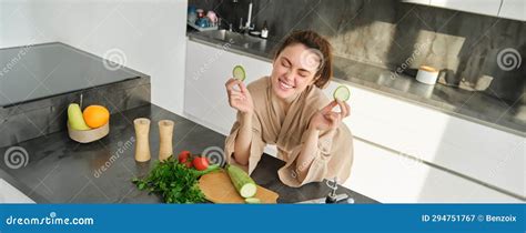 Portrait Of Beautiful Brunette Woman In The Kitchen Wearing Bathrobe Chopping Vegetables On