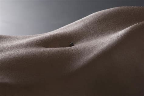 Premium Photo Closeup Of The Abdomen Of A Sexy Naked Woman Against A