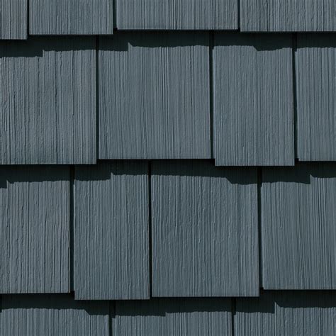 The Roof Of A House That Is Made Out Of Gray Shingles And Wood Planks