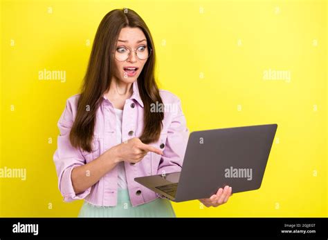 Portrait Of Attractive Nervous Desperate Girl Using Laptop Pointing At Screen Isolated Over