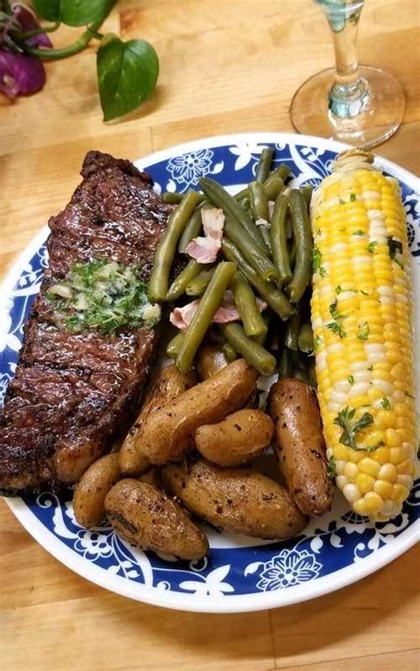 These Grilled Rib Eye Steaks With Roasted Garlic Herb Butter Are The