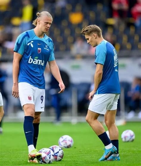 Two Soccer Players Are On The Field With Their Balls And One Is Looking