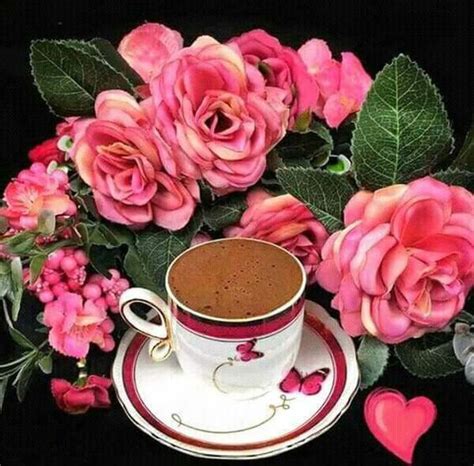 A Cup Of Coffee And Some Pink Flowers On A Saucer With Hearts Around It