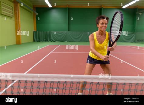 Beautiful Mature Woman Playing Tennis Hi Res Stock Photography And