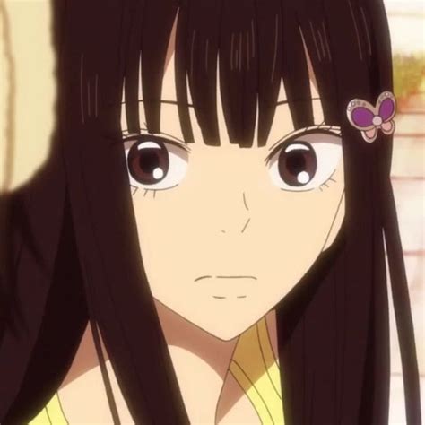 An Anime Girl With Long Black Hair Wearing A Yellow Shirt And Flower In