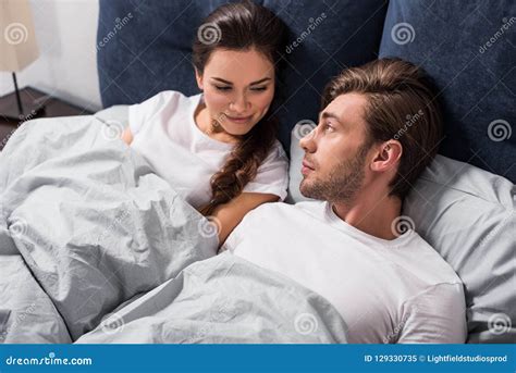 Smiling Man And Woman Lying In Bed Stock Image Image Of Brunette