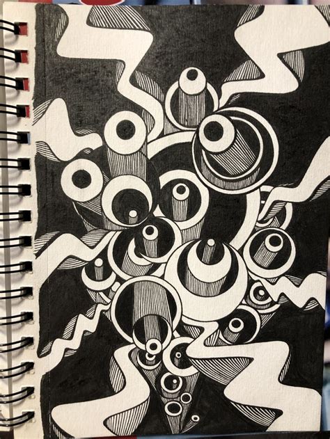 A Spiral Notebook With Black And White Drawings On It